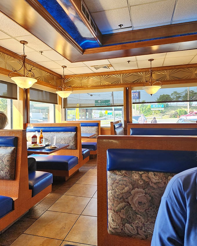 Blue vinyl booths bathed in natural light—the classic diner seating arrangement that somehow makes everything taste just a little bit better.