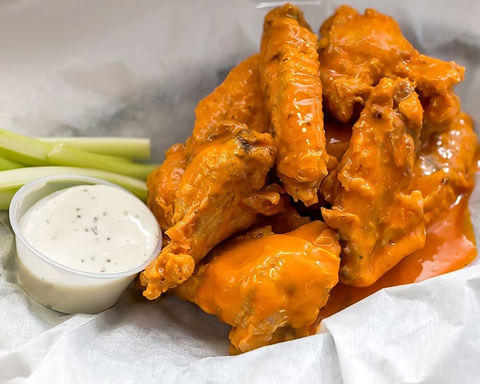 Buffalo wings that don't mess around – crispy, saucy, and unapologetically orange, with blue cheese dip standing by for emergency cooldown.