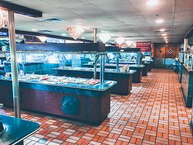 The buffet station stretches before you like a runway of possibilities – each step revealing new temptations under warm lights.