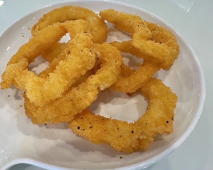 Golden-fried calamari rings—the gateway seafood for the hesitant. Crispy, tender, and impossible to stop eating once you start.