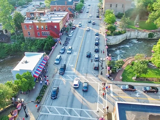From above, the village reveals its perfect composition—a waterfall at its heart, historic buildings lining its streets, and nature embracing it all.