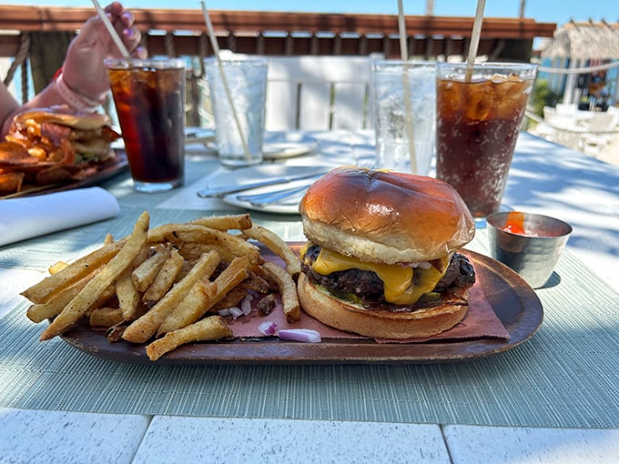 The classic American cheeseburger gets the oceanfront treatment, proving that sometimes the simple pleasures taste even better with a water view.