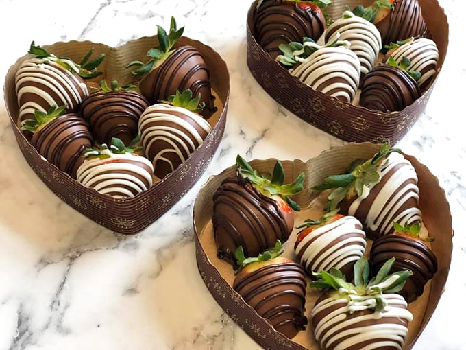 Chocolate-dipped strawberries nestled in heart-shaped boxes – proof that sometimes the simplest combinations make the most profound impressions.