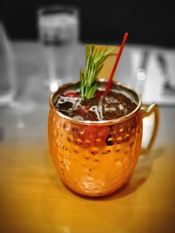 This copper mug doesn't just hold a Moscow Mule—it cradles liquid history with a sprig of rosemary standing guard. Prohibition is definitely over.
