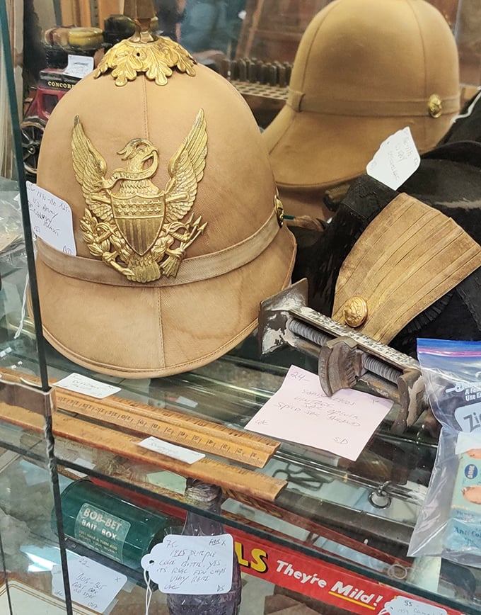 Military helmets and measuring tools share display space – the unexpected juxtapositions are what make antique hunting an adventure in historical context.