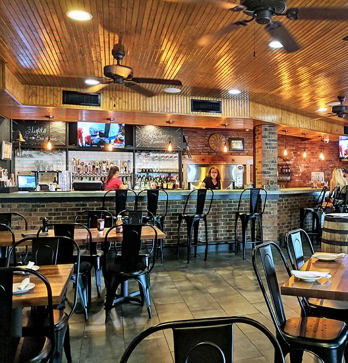 The dining area's blend of wood, brick, and metal creates the perfect backdrop for the serious business of barbecue appreciation.