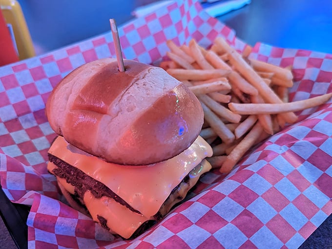 A burger that requires both hands and a strategy. The toothpick isn't holding it together—it's a flagpole claiming this mountain of deliciousness for America. 