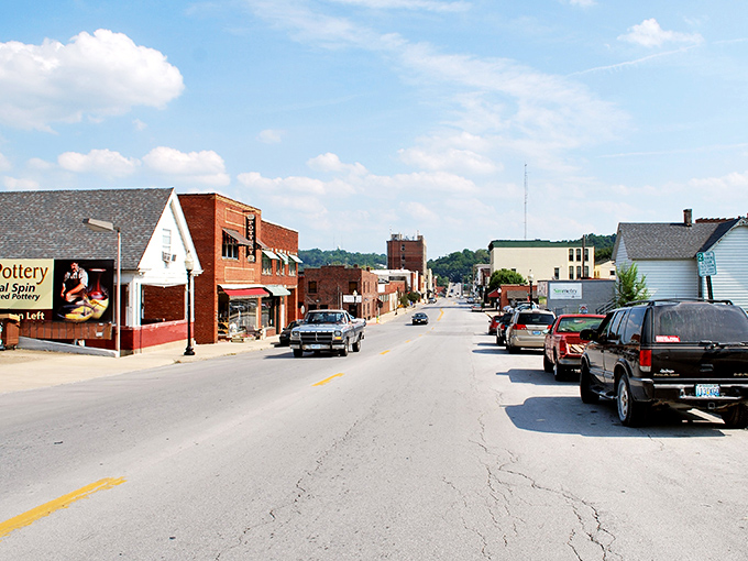 Main Street stretches toward the horizon, a ribbon of small-town commerce where shopkeepers still say "see you tomorrow" and mean it.