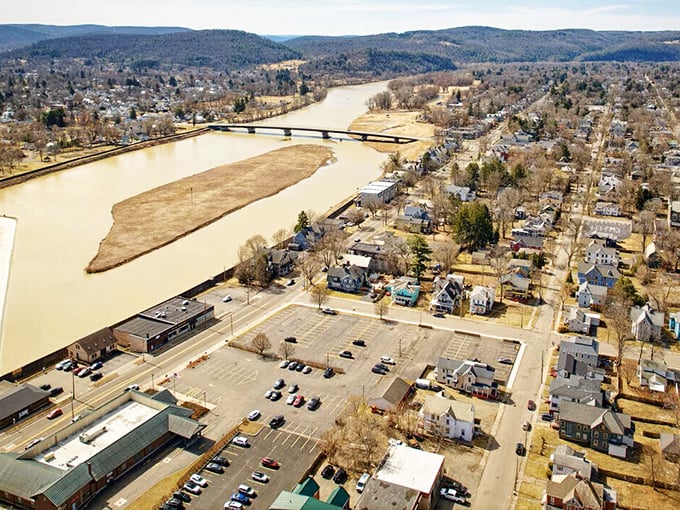 The Chemung River winds through Elmira like a ribbon tying together neighborhoods where people actually know their neighbors' names.
