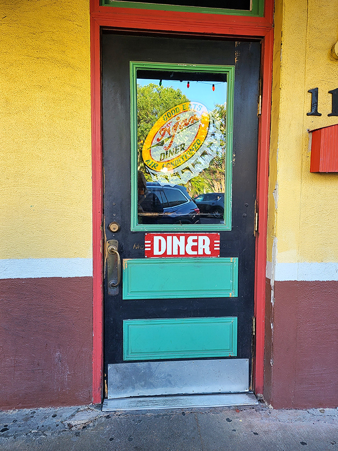 That iconic bottle cap logo on the door is like a wink from an old friend, promising that everything's going to be alright once you step inside.