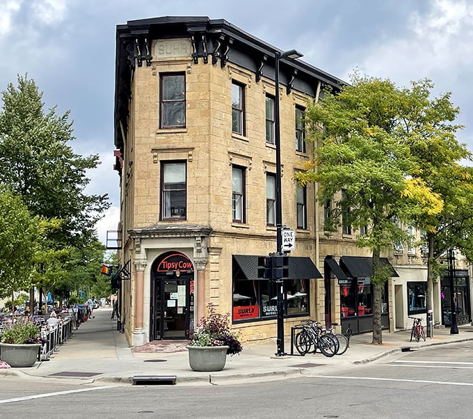 The historic corner building housing Tipsy Cow stands proud, like the architectural equivalent of comfort food—substantial, timeless, and instantly welcoming.