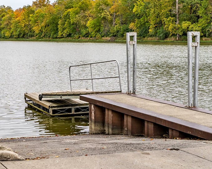 The dock extends into calm waters, offering fishermen, daydreamers, and sunset-watchers the perfect platform for momentary escape from everyday life.