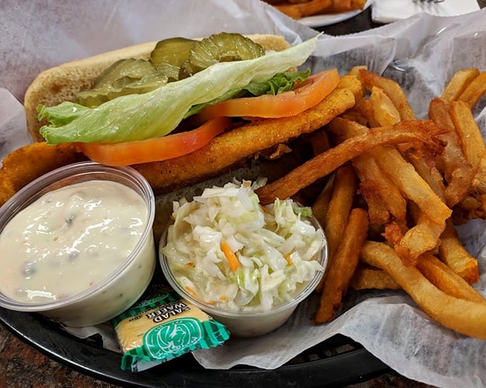 A proper diner basket: crispy fish sandwich, hand-cut fries, and coleslaw—the holy trinity of lunch counter satisfaction.