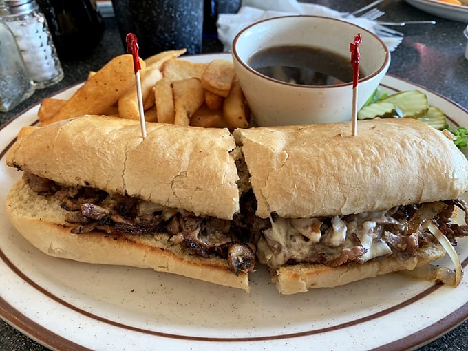 The French Dip at Chubby's—where thinly sliced beef meets its soulmate in a crusty roll, with a side of au jus for that perfect dipping romance.