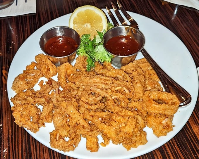 Fried calamari that defies the rubbery reputation – crispy, tender, and ready for its close-up with those dipping sauces.