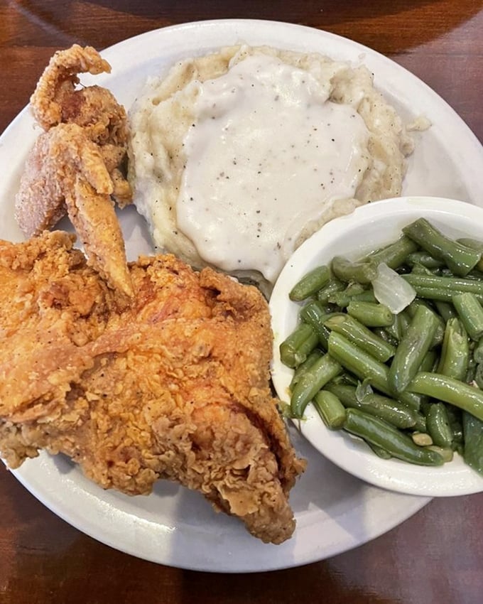 The holy trinity of comfort: fried chicken, mashed potatoes with gravy, and green beans. This plate doesn't just feed your body—it nourishes your soul.