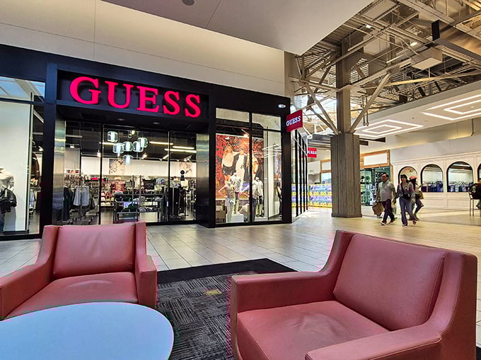 The iconic Guess store with its bold signage and comfortable waiting area—because shopping companions deserve a comfortable place to rest.