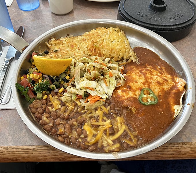 Huevos Rancheros served on a sizzling platter—a breakfast fiesta where crispy hash browns, beans, and ranchero sauce throw the morning's best party.