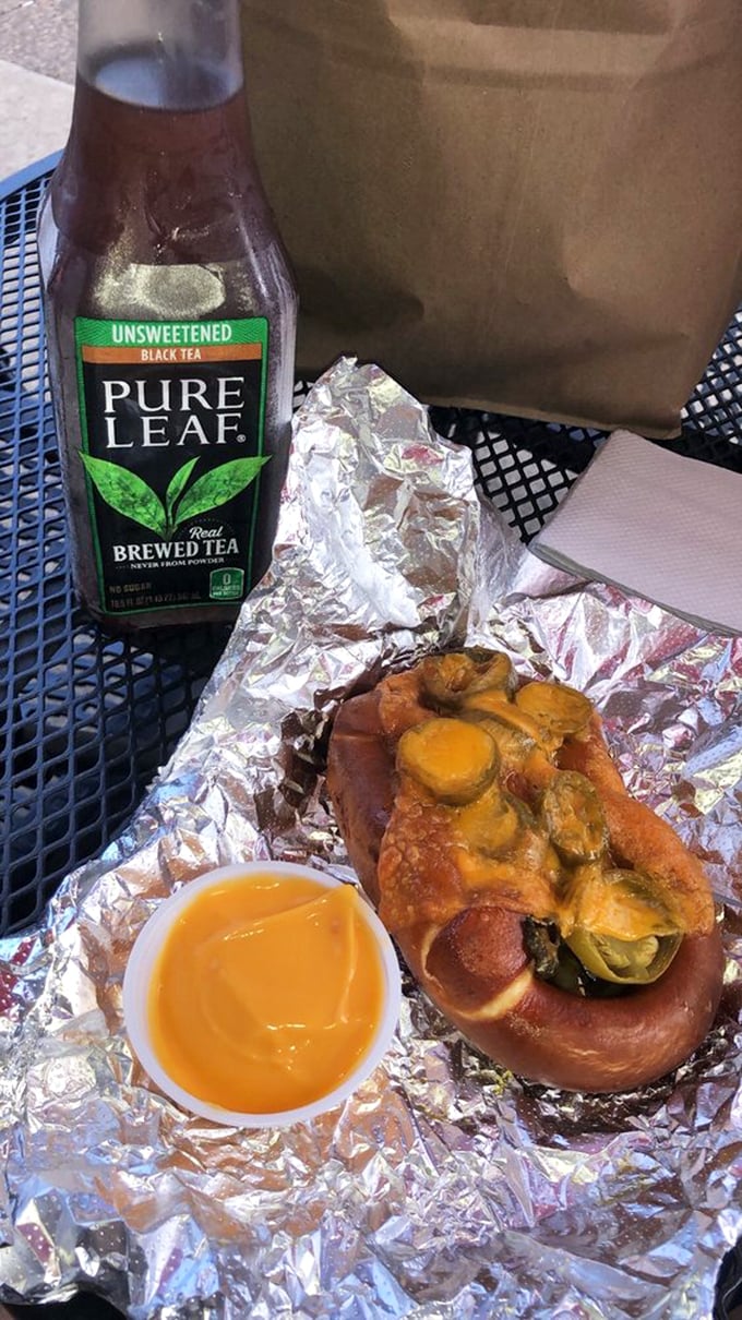 The jalapeño cheddar pretzel with dipping sauce—where heat meets sweet meets savory in a holy trinity of flavor that demands an ice-cold drink alongside.