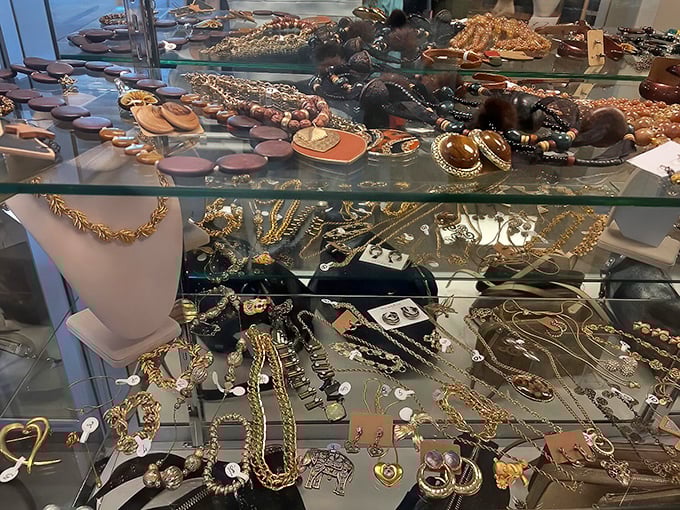 Jewelry displayed like buried treasure – some costume, some possibly valuable, all with stories to tell. That vintage brooch could be your next conversation starter. 