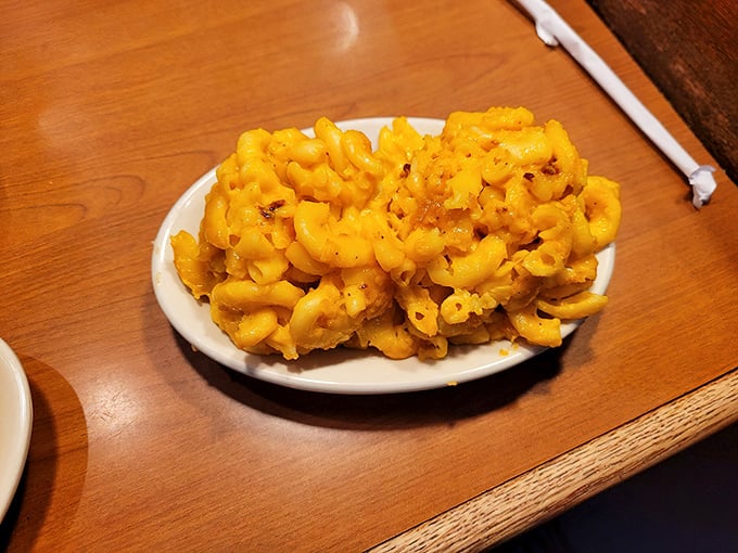 Mac and cheese that doesn't just comfort—it embraces. This isn't a side dish; it's the supporting actor that steals every scene.