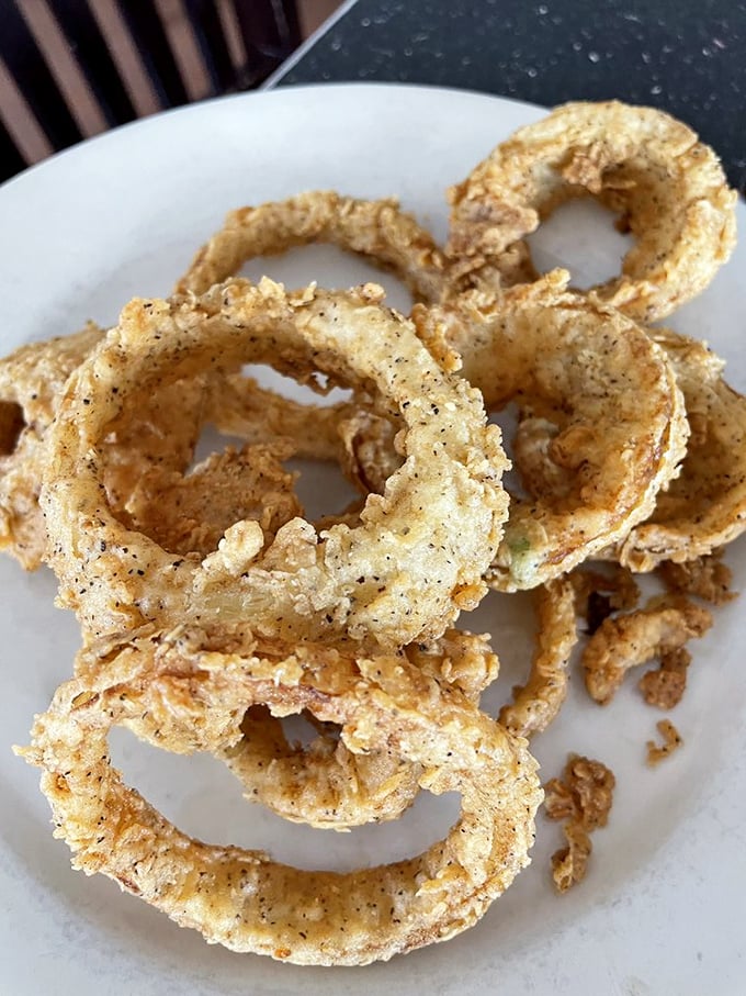 Onion rings that shatter with each bite—crispy, golden halos that make you wonder why anyone would ever settle for the frozen kind.
