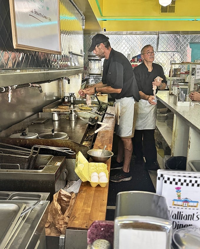 The open kitchen where breakfast magic happens—no smoke and mirrors, just skilled hands and decades of experience.