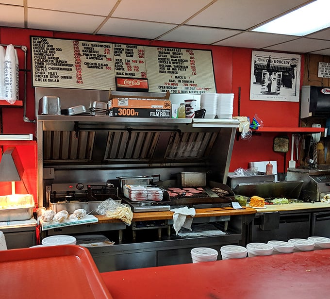 Where the magic happens—this open kitchen has no secrets, just decades of burger-making wisdom and a flat-top grill seasoned with history.