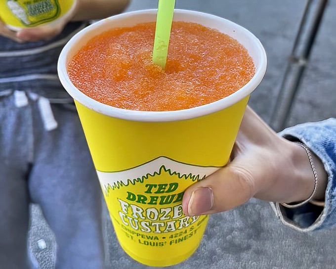 The orange slush—summer's perfect antidote in that signature yellow cup. Like drinking a sunset after it's been properly chilled.