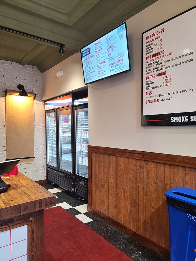 Clean lines, wooden accents, and that menu board – the calm before the flavor storm. This isn't just a restaurant; it's a temple of smoke.