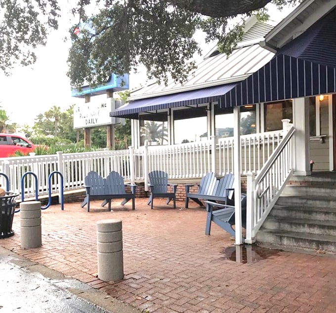 The outdoor seating area feels like a friend's coastal cottage. Those blue chairs have heard more vacation stories than any therapist in town.