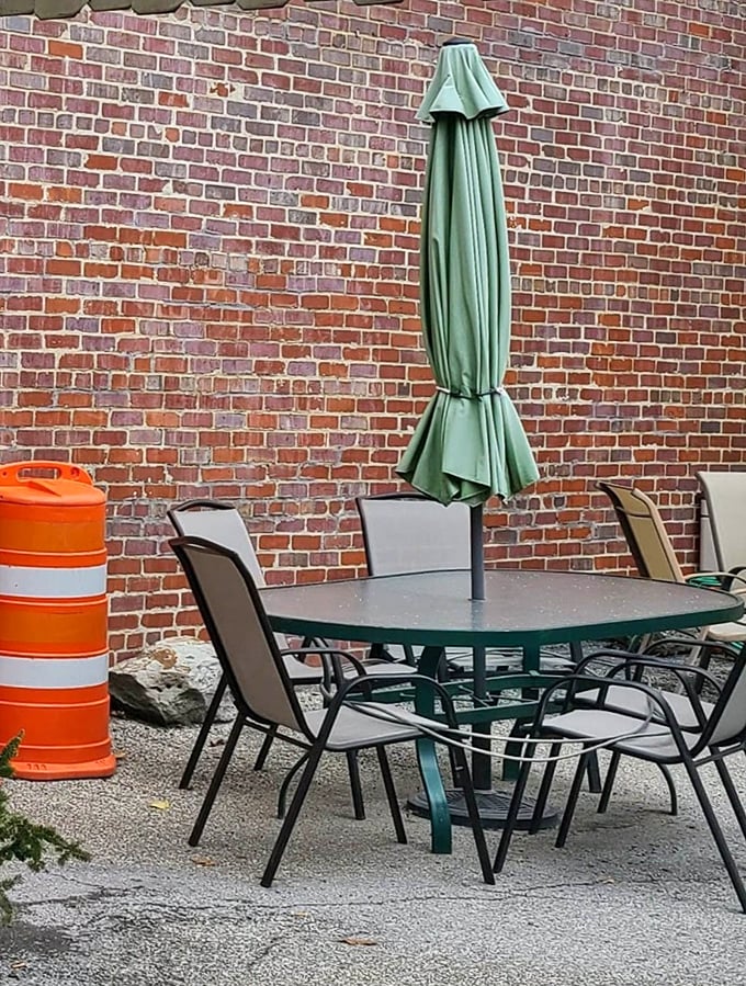 The modest outdoor seating area isn't trying to impress Instagram—it's simply offering fresh air with your legendary sandwich experience.