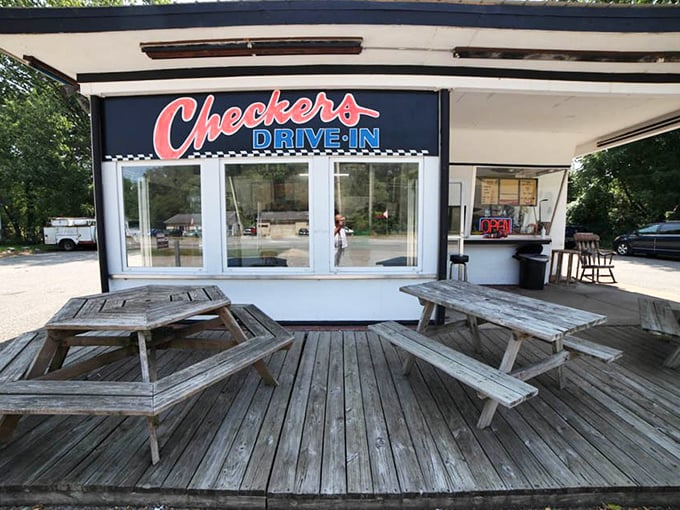 Weathered picnic tables on a wooden deck—nature's dining room where conversations flow as freely as the ketchup.