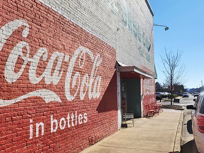 That Coca-Cola wall mural isn't trendy design—it's authentic Americana that's weathered decades of Alabama sunshine while welcoming hungry visitors to this timeless establishment.