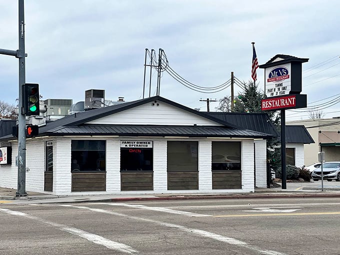 The white exterior with dark trim and American flag presents a classic small-town diner profile. In a world of culinary trends, Mr. V's stands for timeless satisfaction.