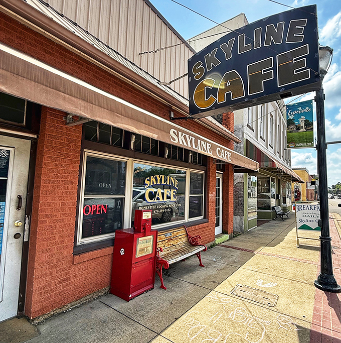 That red bench outside isn't just seating – it's a front-row ticket to small-town Arkansas life, with the best pre-meal show in town.