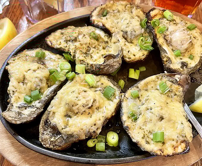 These aren't just stuffed mushrooms—they're little boats of joy sailing on a sea of butter, topped with melted cheese and green onions.