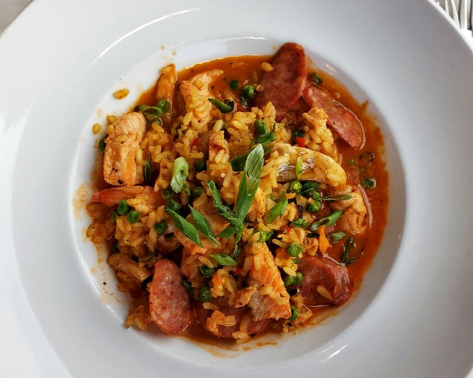 This isn't just paella—it's a colorful Spanish fiesta where rice, seafood, and sausage dance together in perfect harmony on your plate.