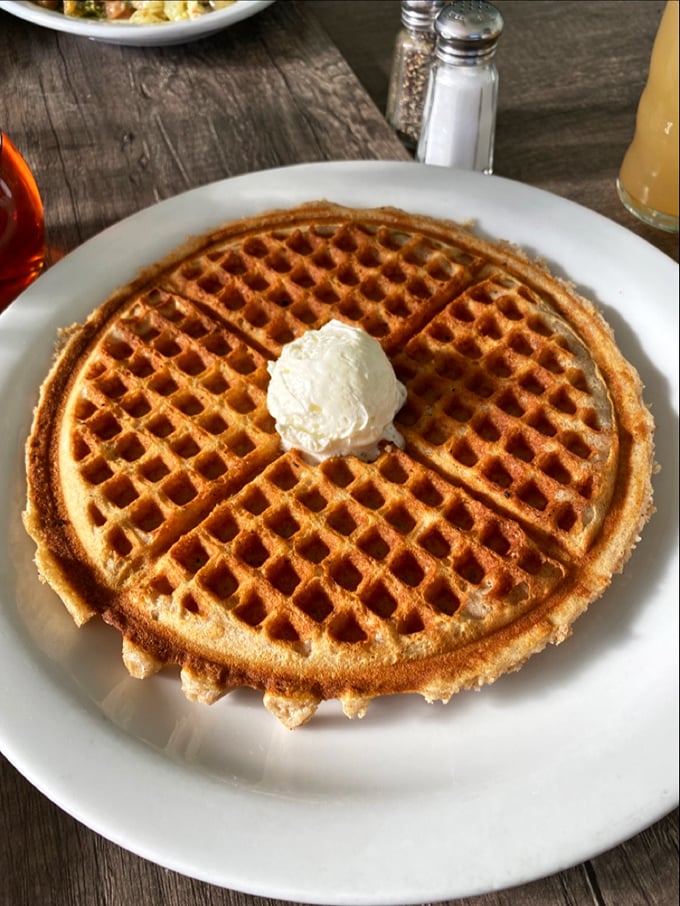 A golden waffle with architectural integrity that would make Frank Lloyd Wright proud—perfectly crisp exterior supporting that cloud-like interior.