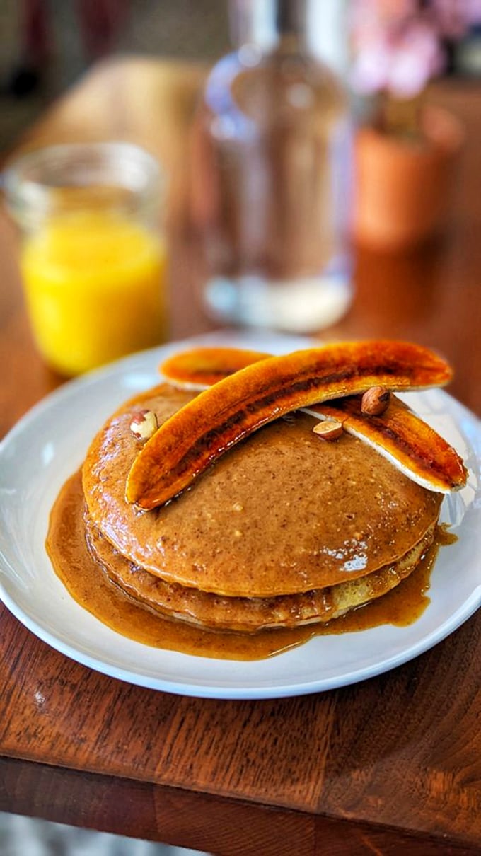 These pancakes, crowned with caramelized bananas, aren't just breakfast—they're what breakfast dreams about when it goes to sleep at night.