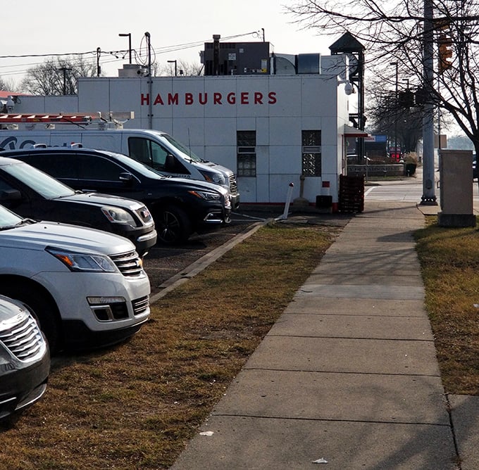 Don't let the humble exterior fool you—some of Michigan's most satisfying meals are served from this unassuming white building with "HAMBURGERS" proudly displayed.