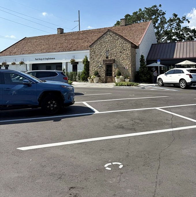 Even the parking lot maintains the charm—a final glimpse of stone and white trim before you reluctantly head home with takeaway containers.
