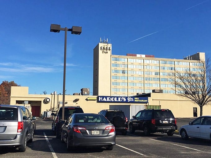The parking lot fills with pilgrims on their quest for pastrami perfection – each car representing someone about to have a life-changing deli experience.