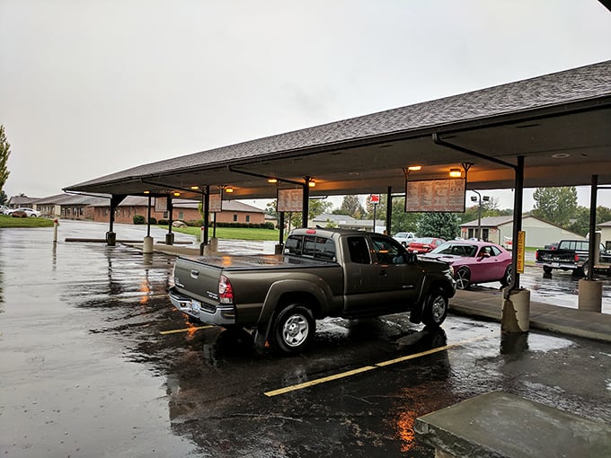 Even on rainy days, the covered parking spots keep the drive-in experience alive. Some traditions are worth preserving, especially delicious ones.