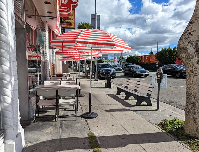 Even the outdoor seating captures the essence of mid-century charm – those striped umbrellas providing shade for conversations and people-watching on Santa Monica Boulevard.
