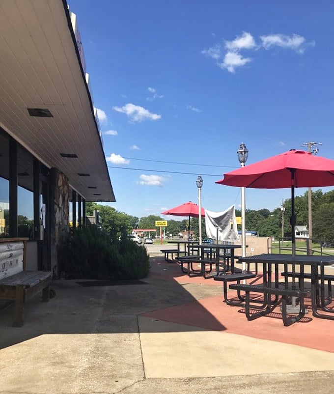 The outdoor seating area offers a place to enjoy your barbecue bounty under Alabama skies – red umbrellas providing shade for serious eating business.