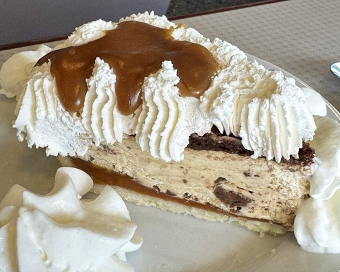 Peanut butter pie with whipped cream sentinels standing guard—proof that sometimes the most unassuming desserts deliver the most profound joy.