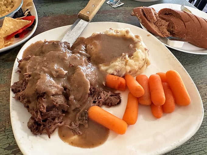 The pot roast dinner isn't just food; it's time travel on a plate – tender beef, gravy-soaked potatoes, and carrots that taste like someone's grandmother is in the kitchen.