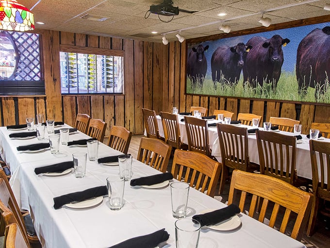 The private dining room, complete with watchful bovine observers on the wall, stands ready for celebrations where "sharing" is definitely not on the menu.