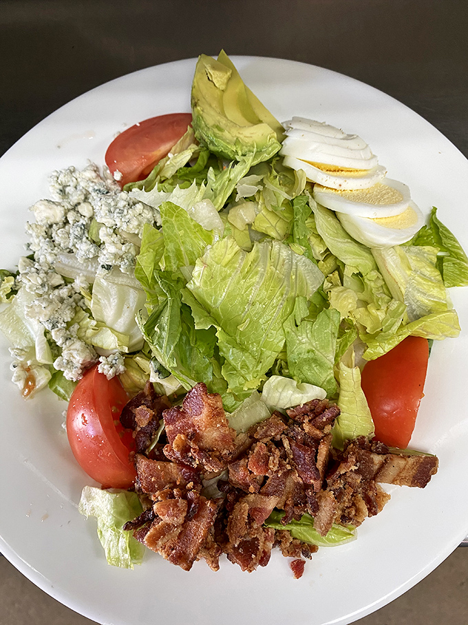 The Cobb salad arrives like edible artwork – a colorful arrangement of ingredients that actually taste as good as they look.